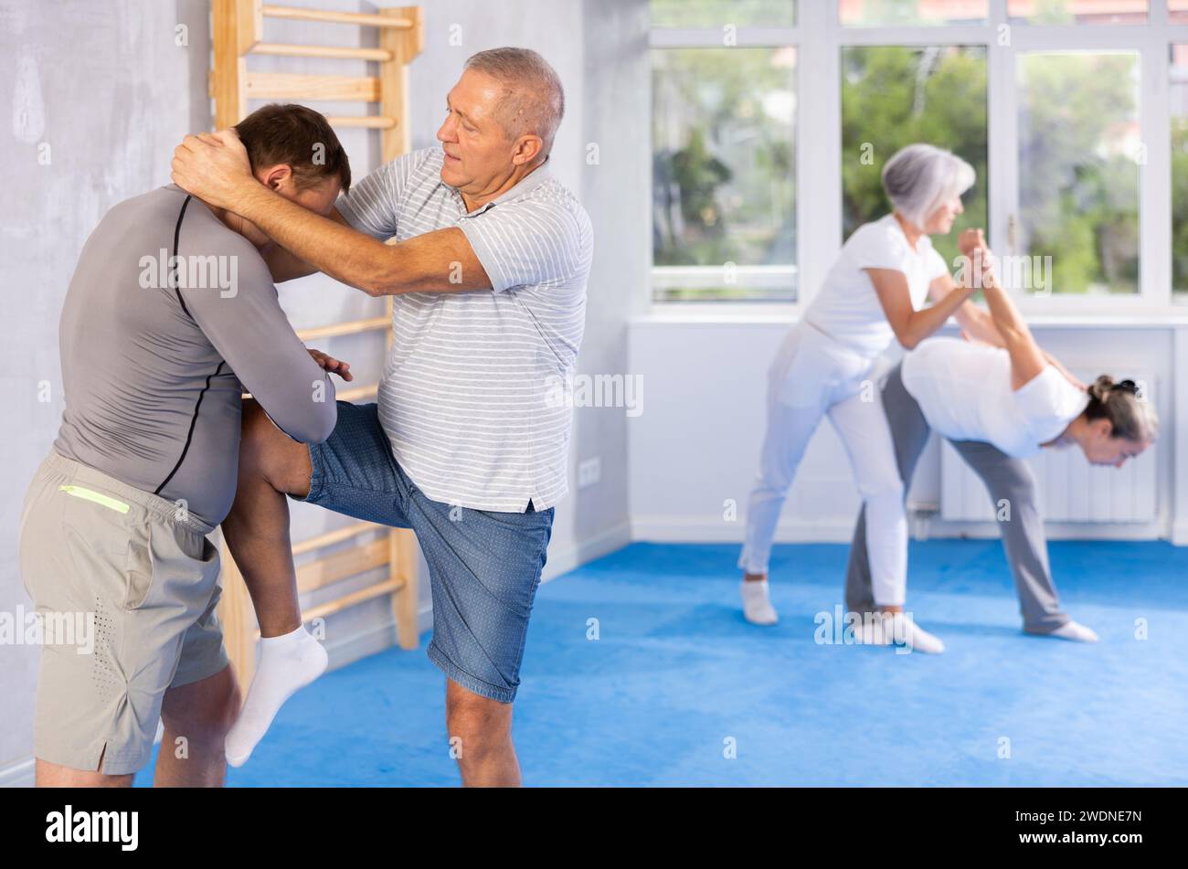 Old man practicing self-defense techniques in pairs Stock Photo - Alamy