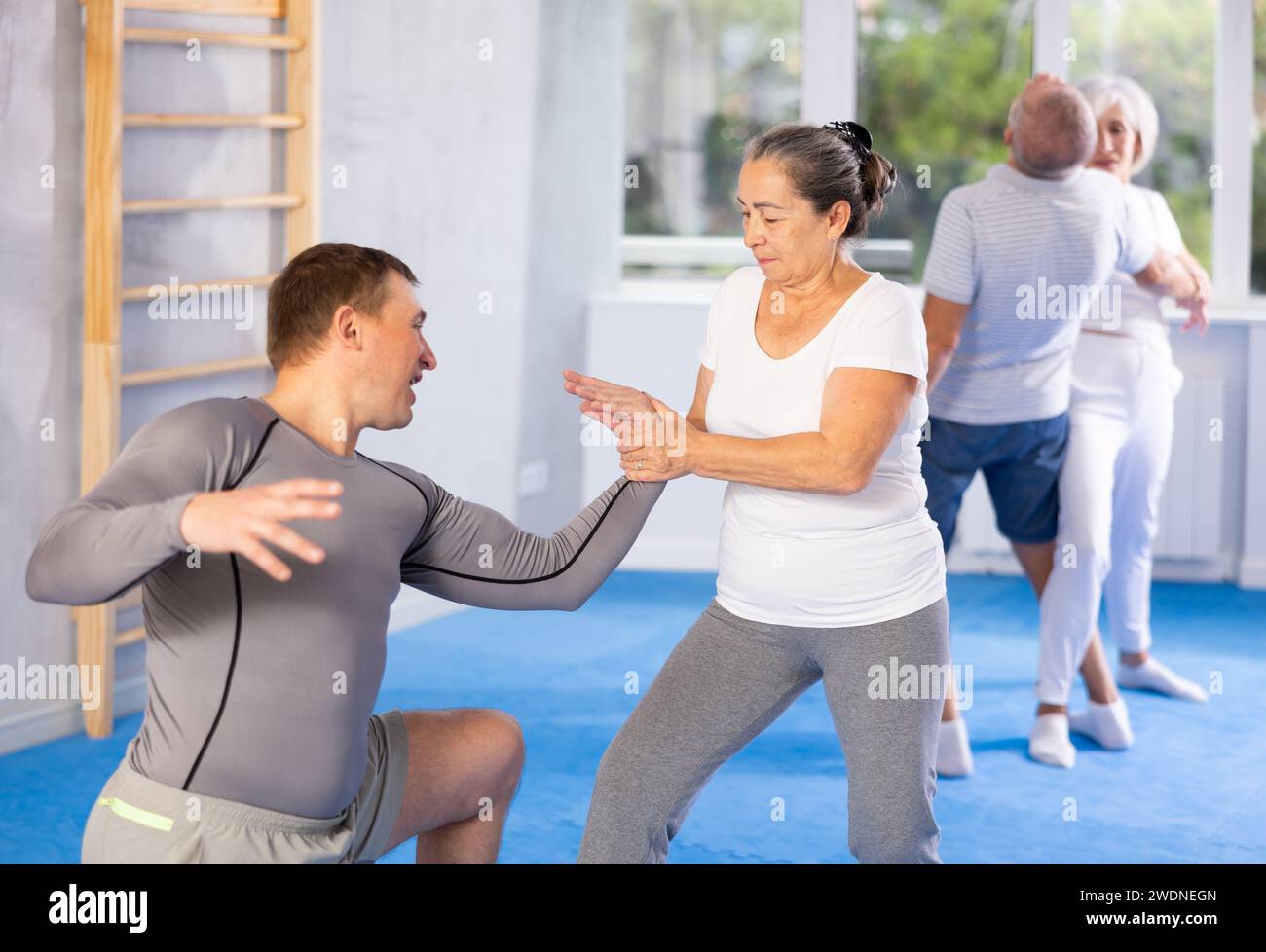 Elderly woman twists arm of attacking man with painful hold in gym ...