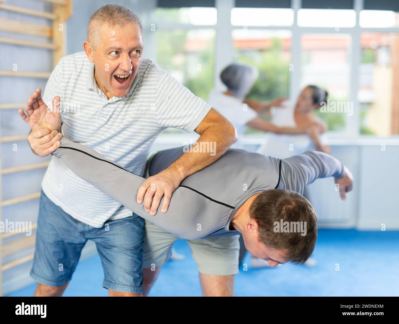 Self defense lesson - elderly man twists the arm of attacking man with ...