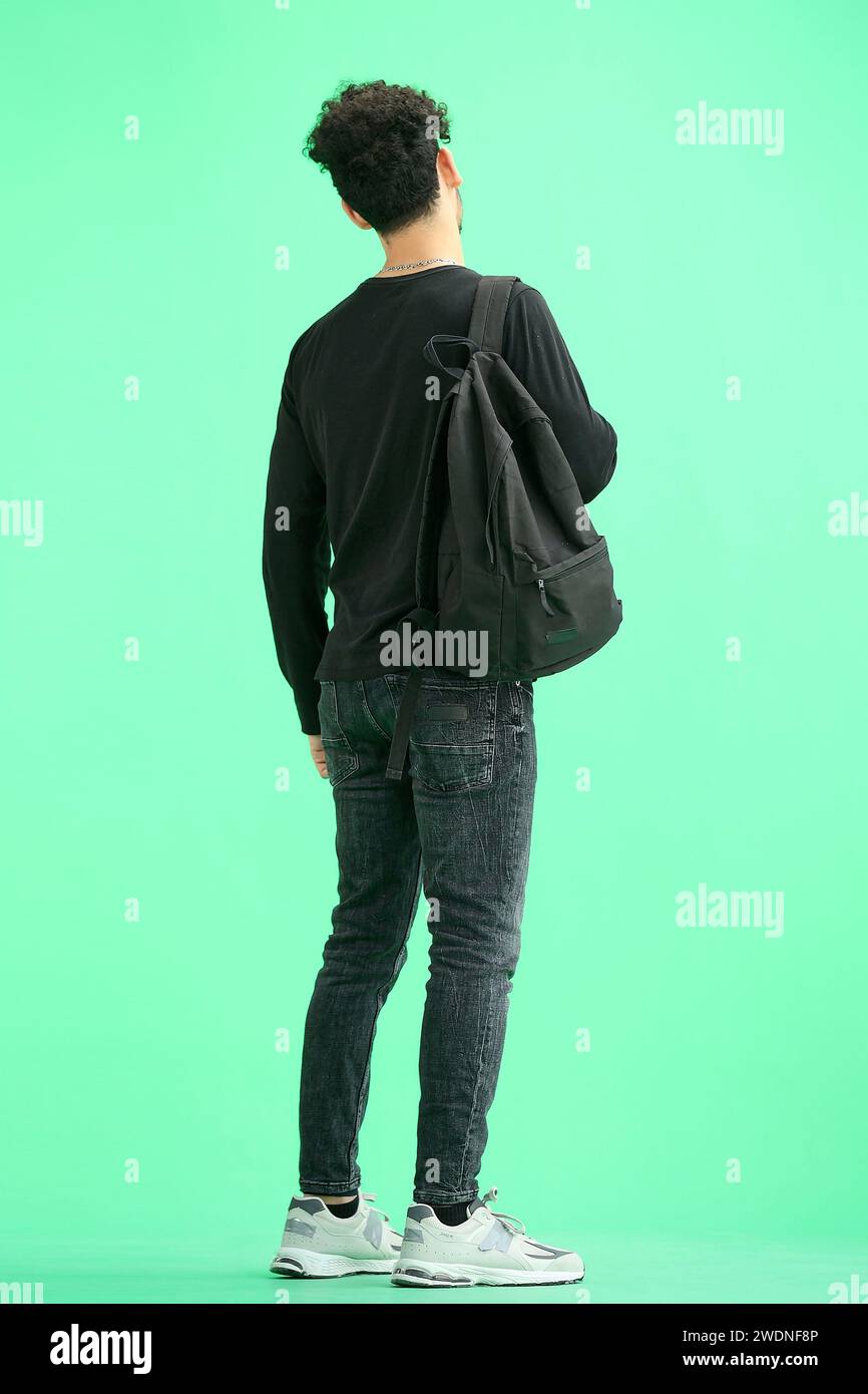 A man, on a green background, full-length, with a backpack Stock Photo ...