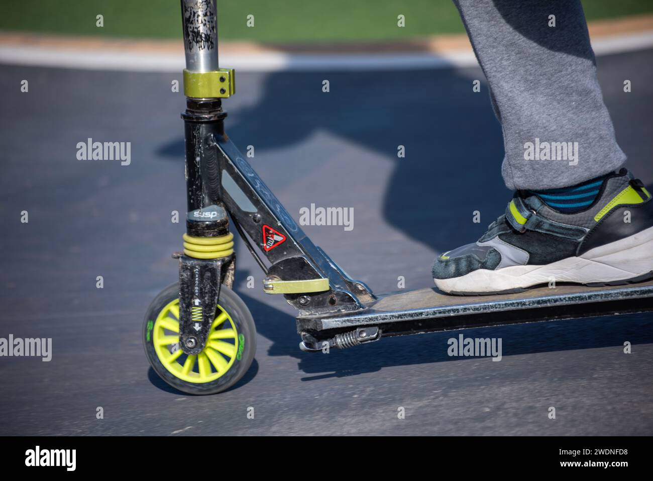 High-speed pumptrack ride: Black and green scooter navigating twists on ...