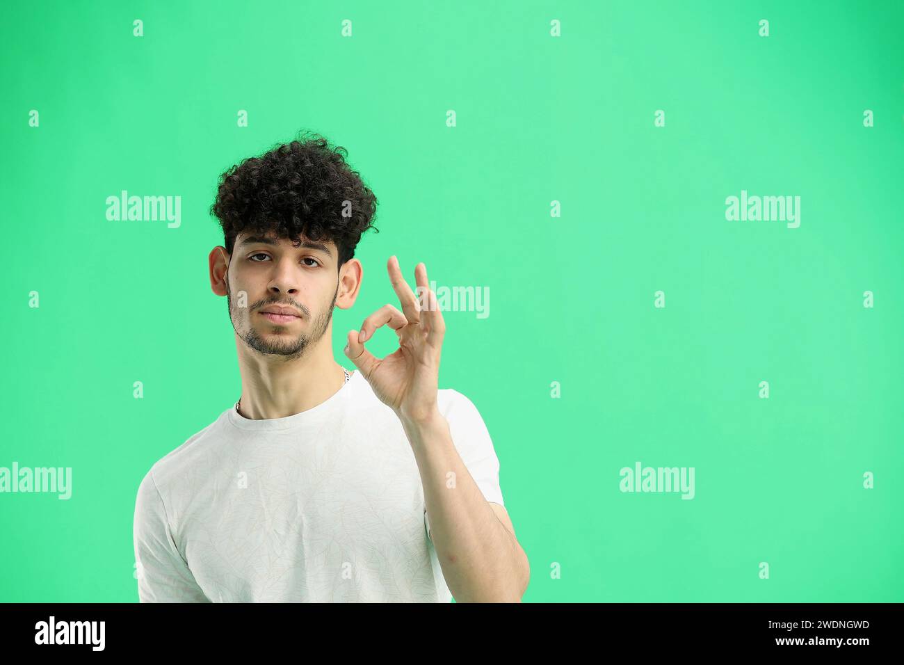 A man, on a green background, in close-up, shows an ok sign Stock Photo ...