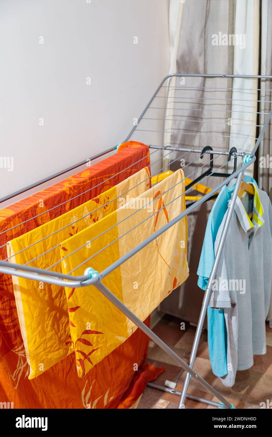 Laundry is displayed on a folding dryer, ready to use Stock Photo - Alamy