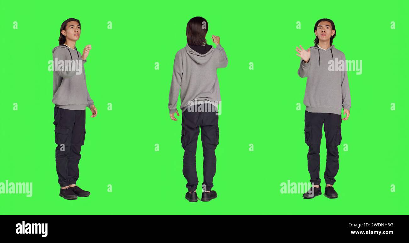 Male model looks at hologram icon on camera with full body greenscreen ...