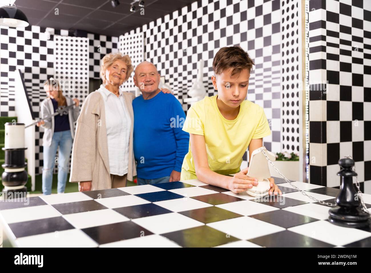 Kids solving riddles in escape room and grandparents watching them ...