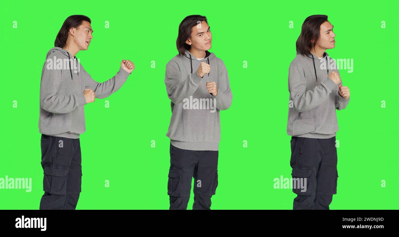 Young man throwing punches in the air, being violent and aggressive in ...