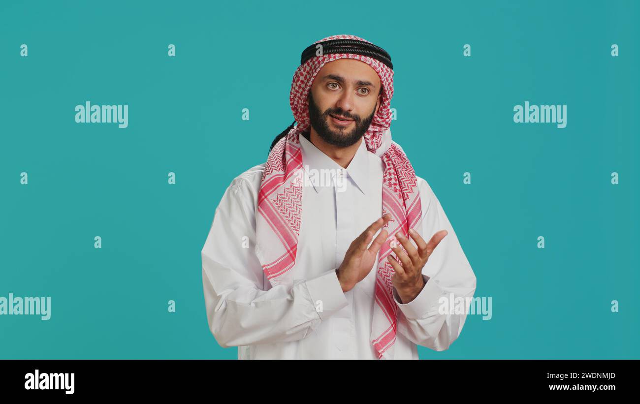 Muslim guy in traditional robe showcasing proud expression while ...