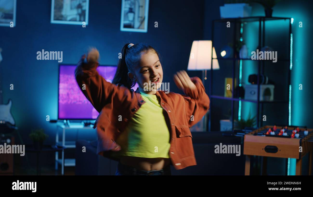 Children influencer dancing in home studio, recording video with mobile ...