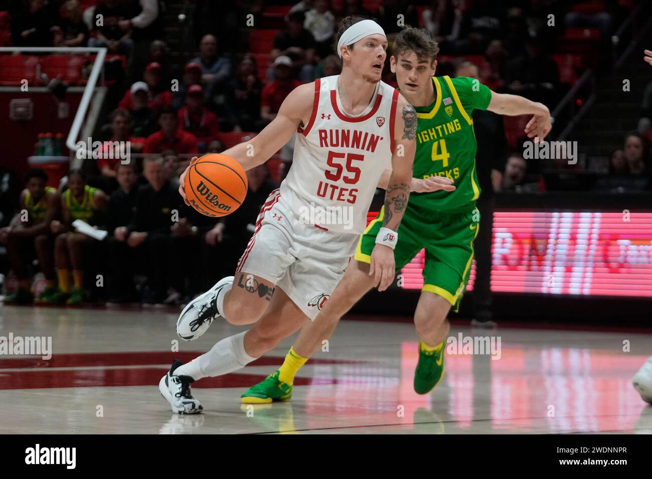 Utah guard Gabe Madsen (55) drives around Oregon guard Brennan Rigsby ...
