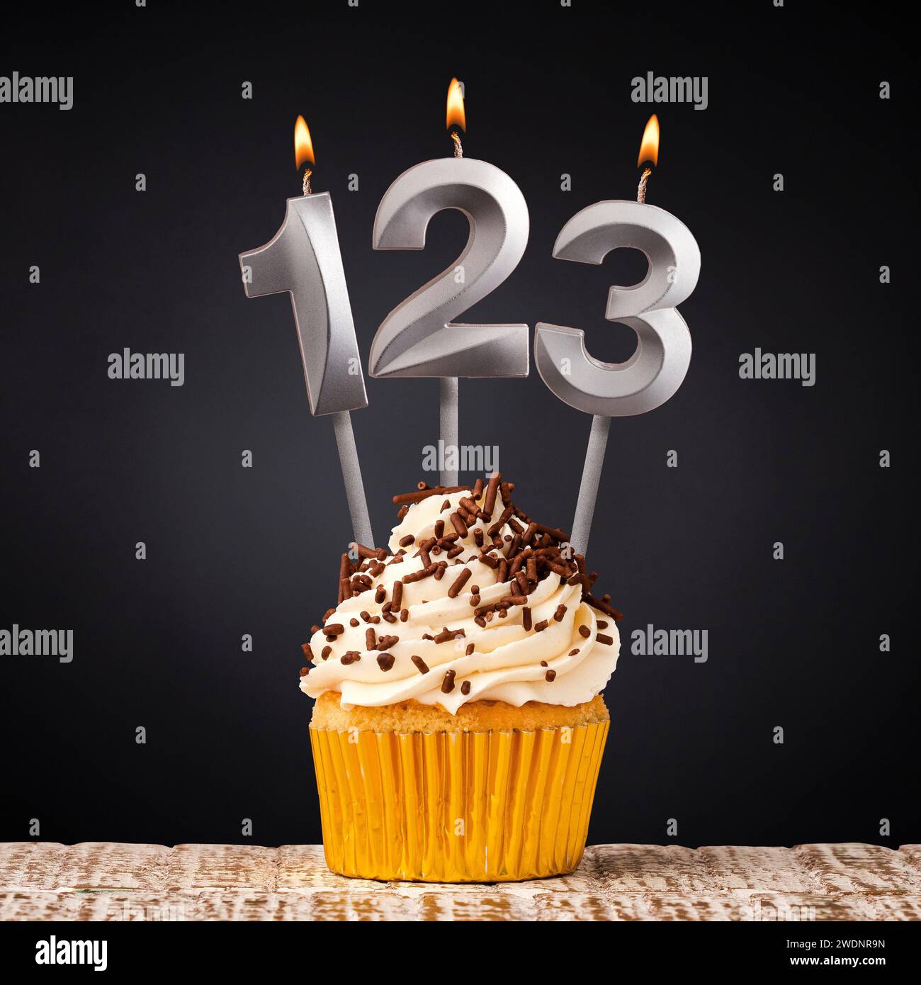 Birthday candle number 123 - Anniversary cupcake on black background ...