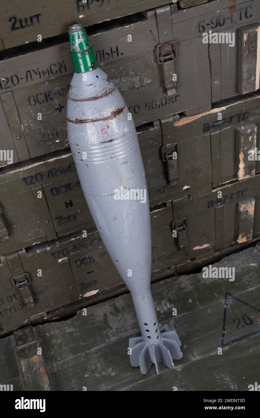 120 mm mortar shell on army green crate. Text in russian - type of ...