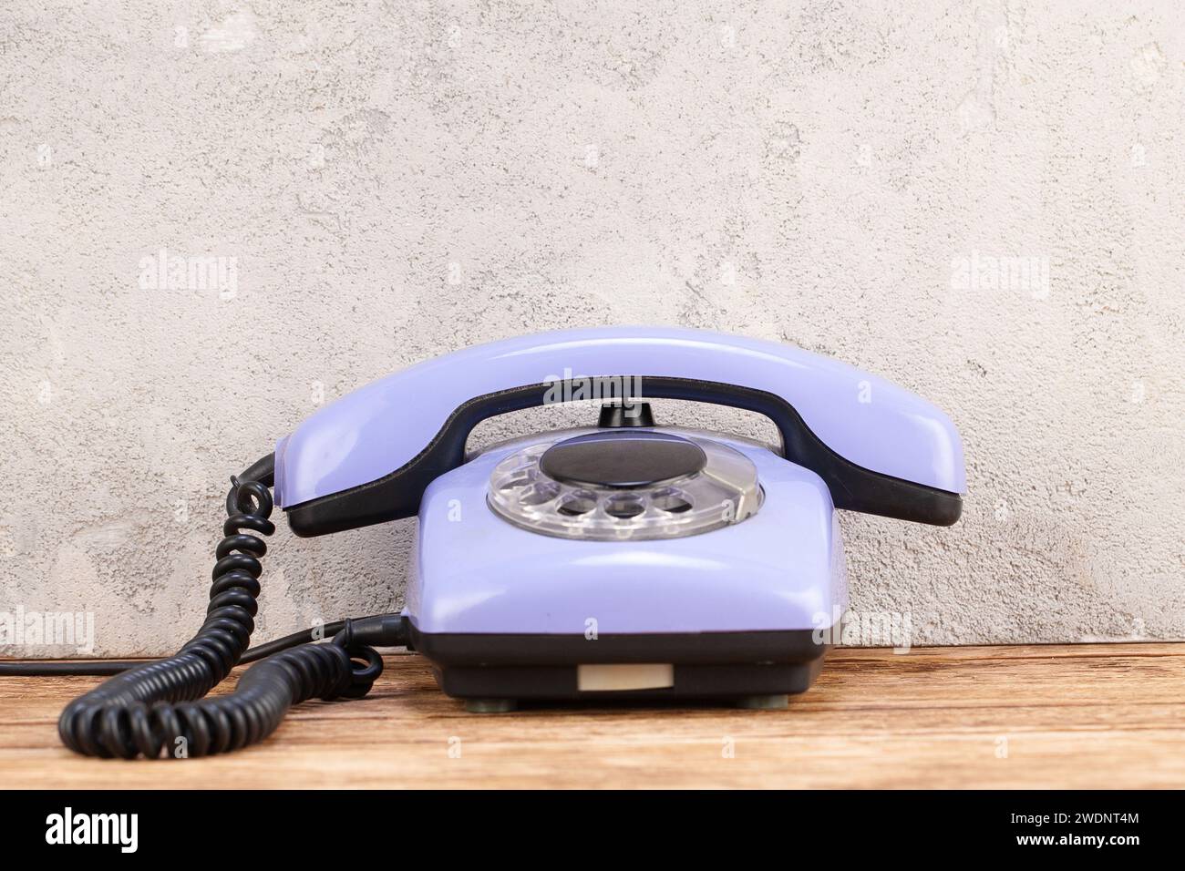 Vintage blue rotary dial telephone on wooden table in front gray ...