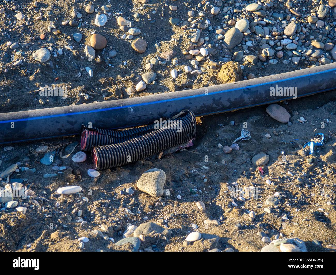 pipe with communications was dug on pebble soil. Electrical networks in ...