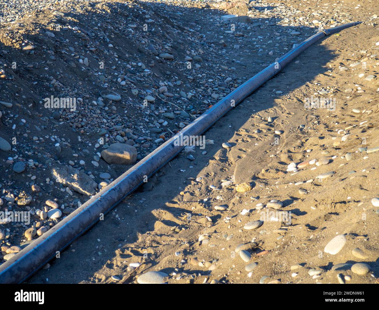 pipe with communications was dug on pebble soil. Electrical networks in ...