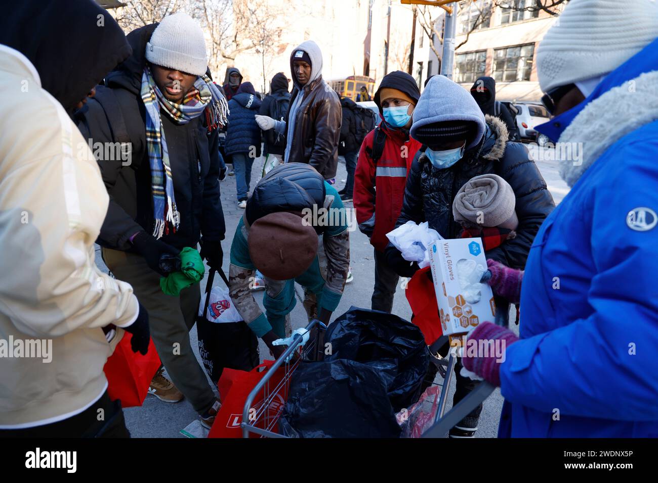 Migrants Who Have Been Forced Out Of Shelters Receive Food And Clothing