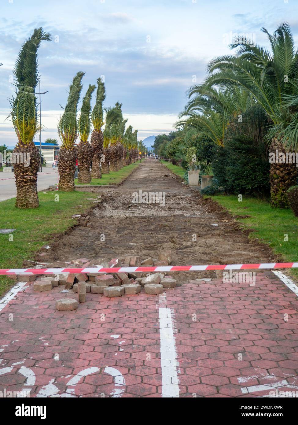 Reconstruction of the bike path. Replacing tiles on a bike path among ...