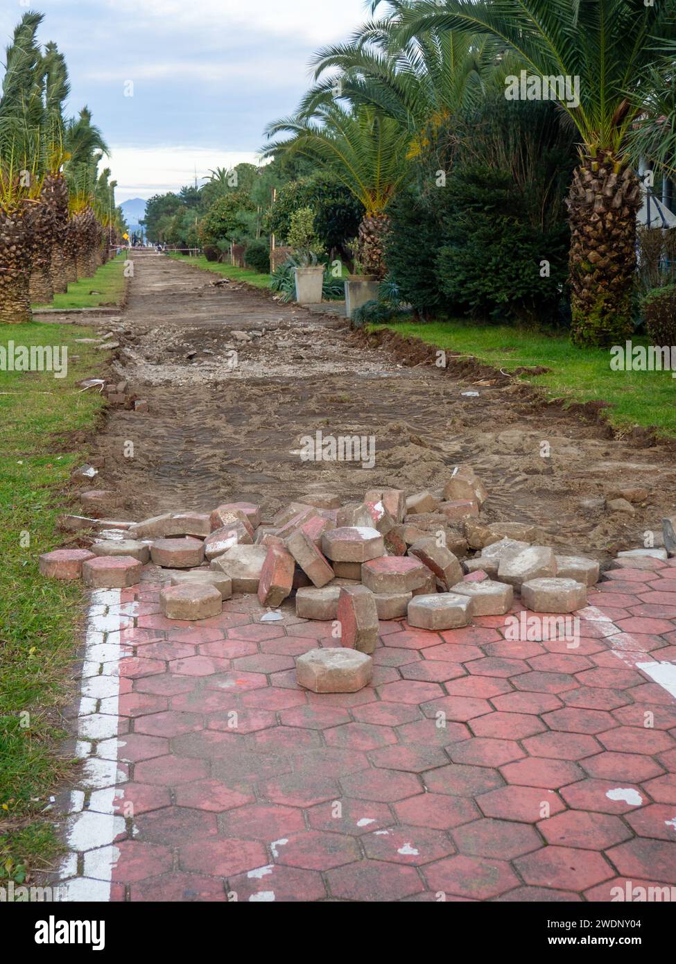 Reconstruction of the bike path. Replacing tiles on a bike path among ...