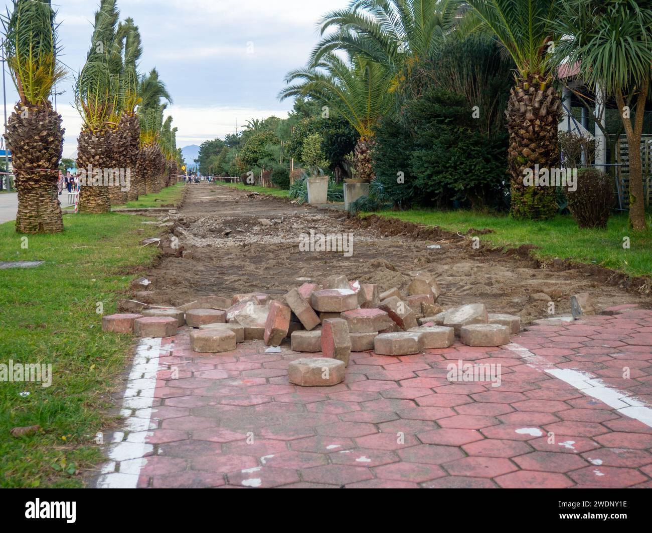 Reconstruction of the bike path. Replacing tiles on a bike path among ...