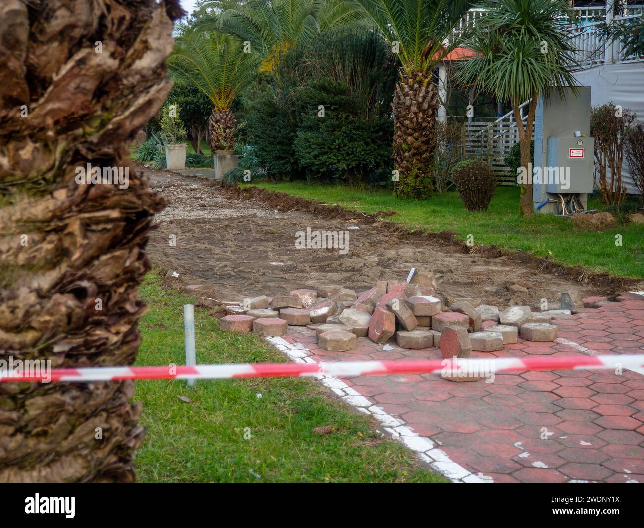 Reconstruction of the bike path. Replacing tiles on a bike path among ...