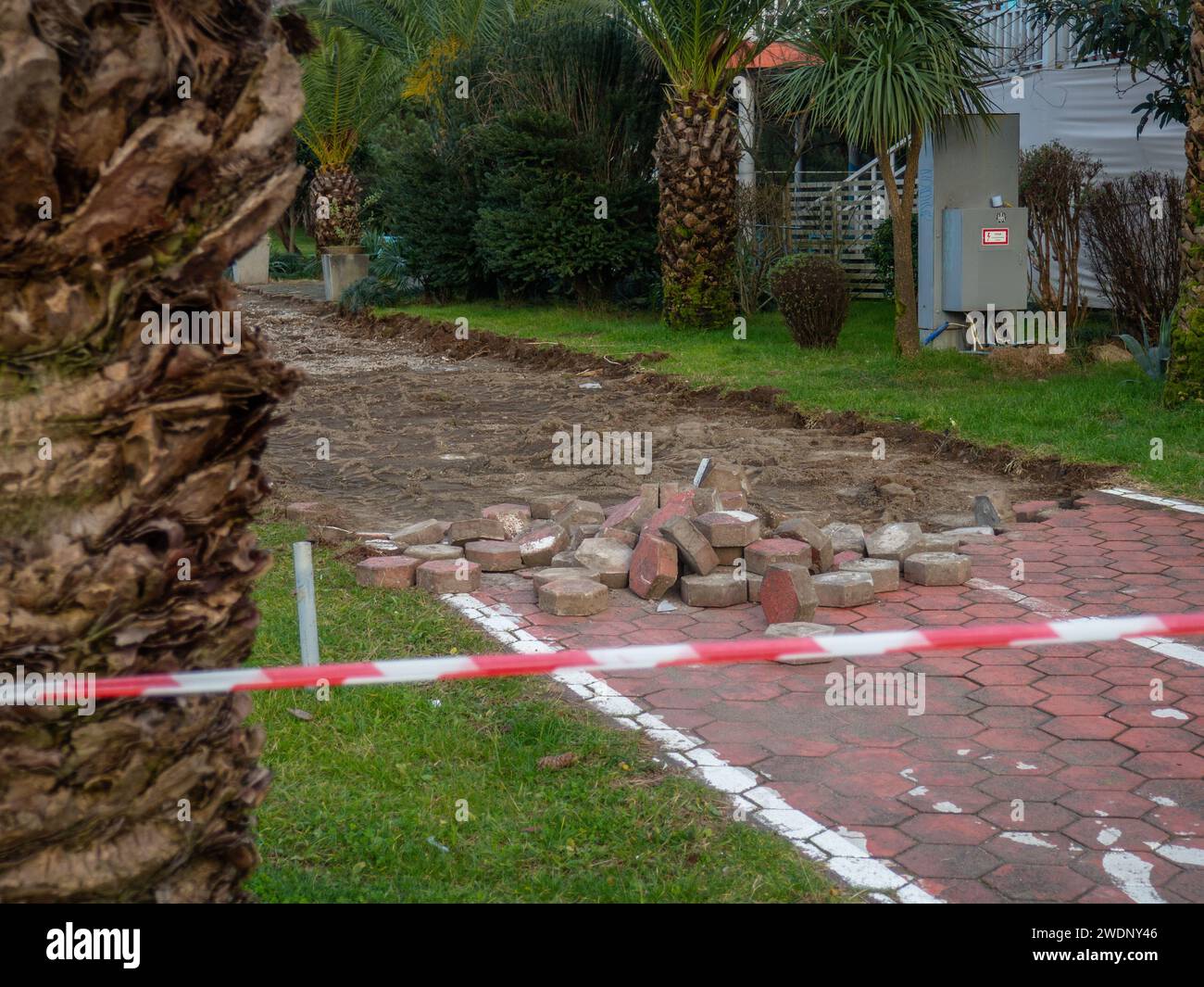 Reconstruction of the bike path. Replacing tiles on a bike path among ...