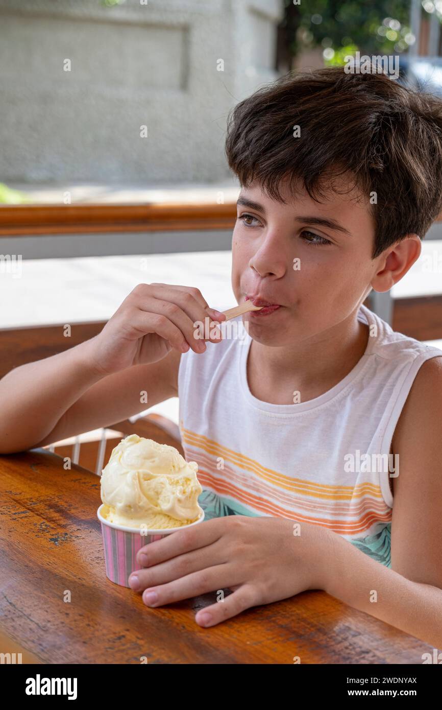10 year old Brazilian child eating ice cream on a sunny afternoon 2 ...