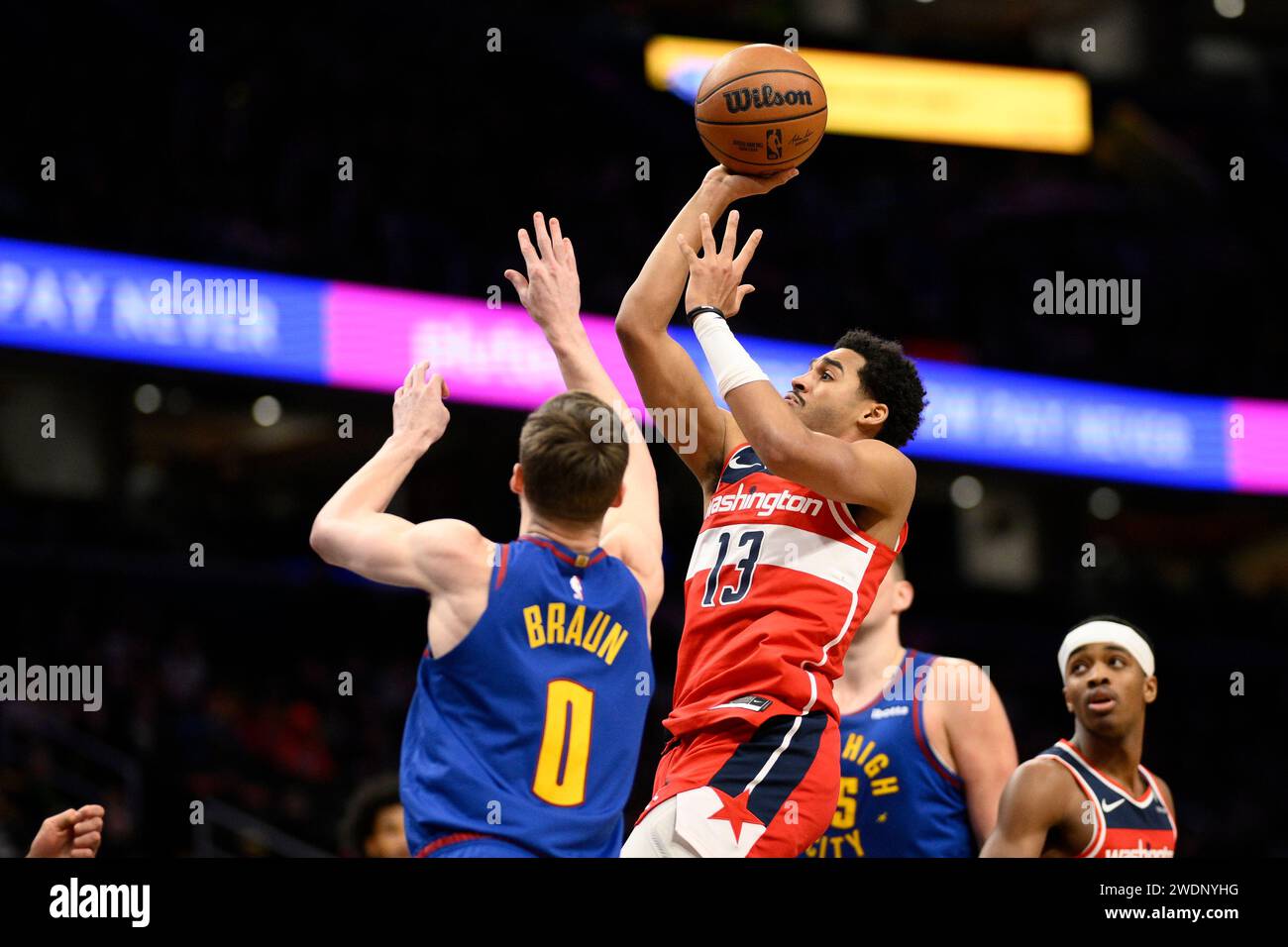 Washington Wizards guard Jordan Poole shoots against Denver Nuggets guard Christian Braun (0 ...
