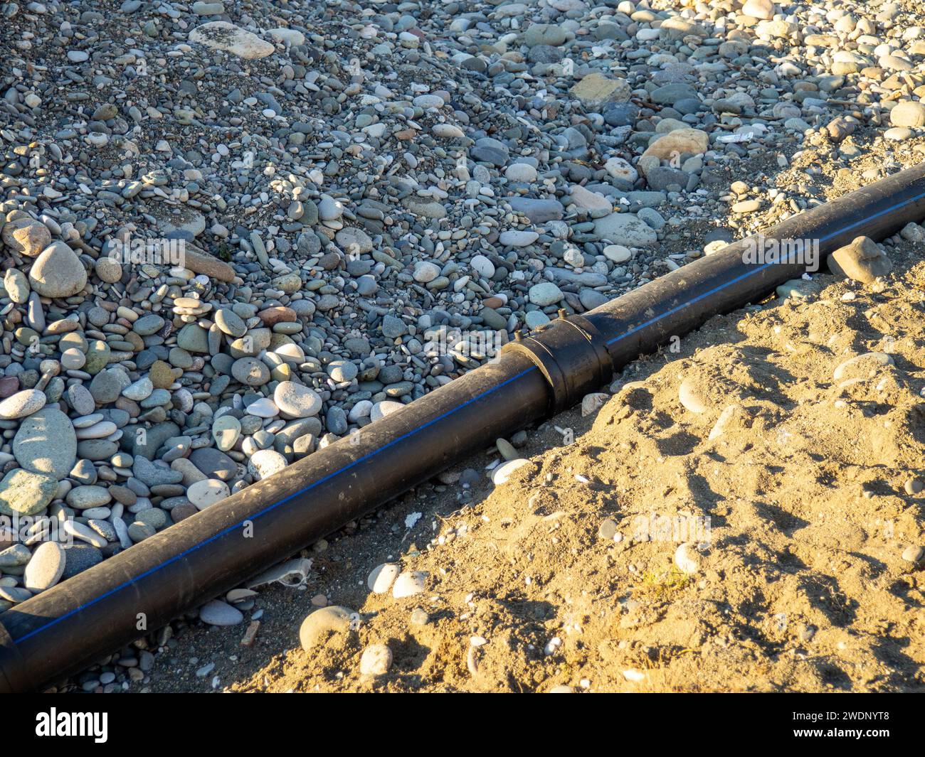 pipe with communications was dug on pebble soil. Electrical networks in ...