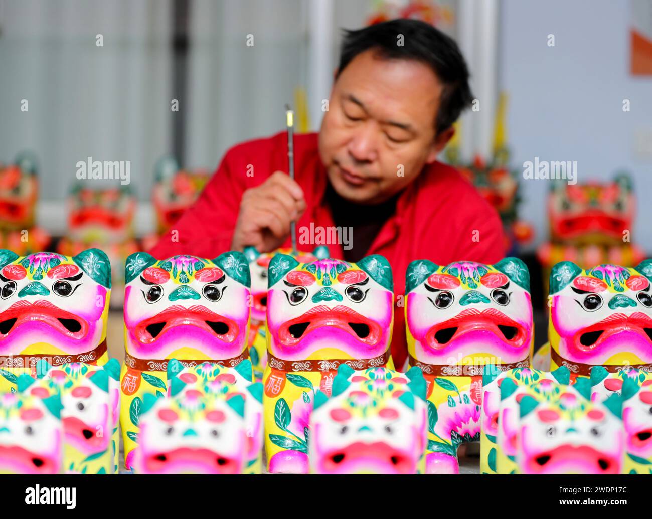 GAOMI, CHINA - JANUARY 21, 2024 - Villager Nie Laichen paints "mud ...