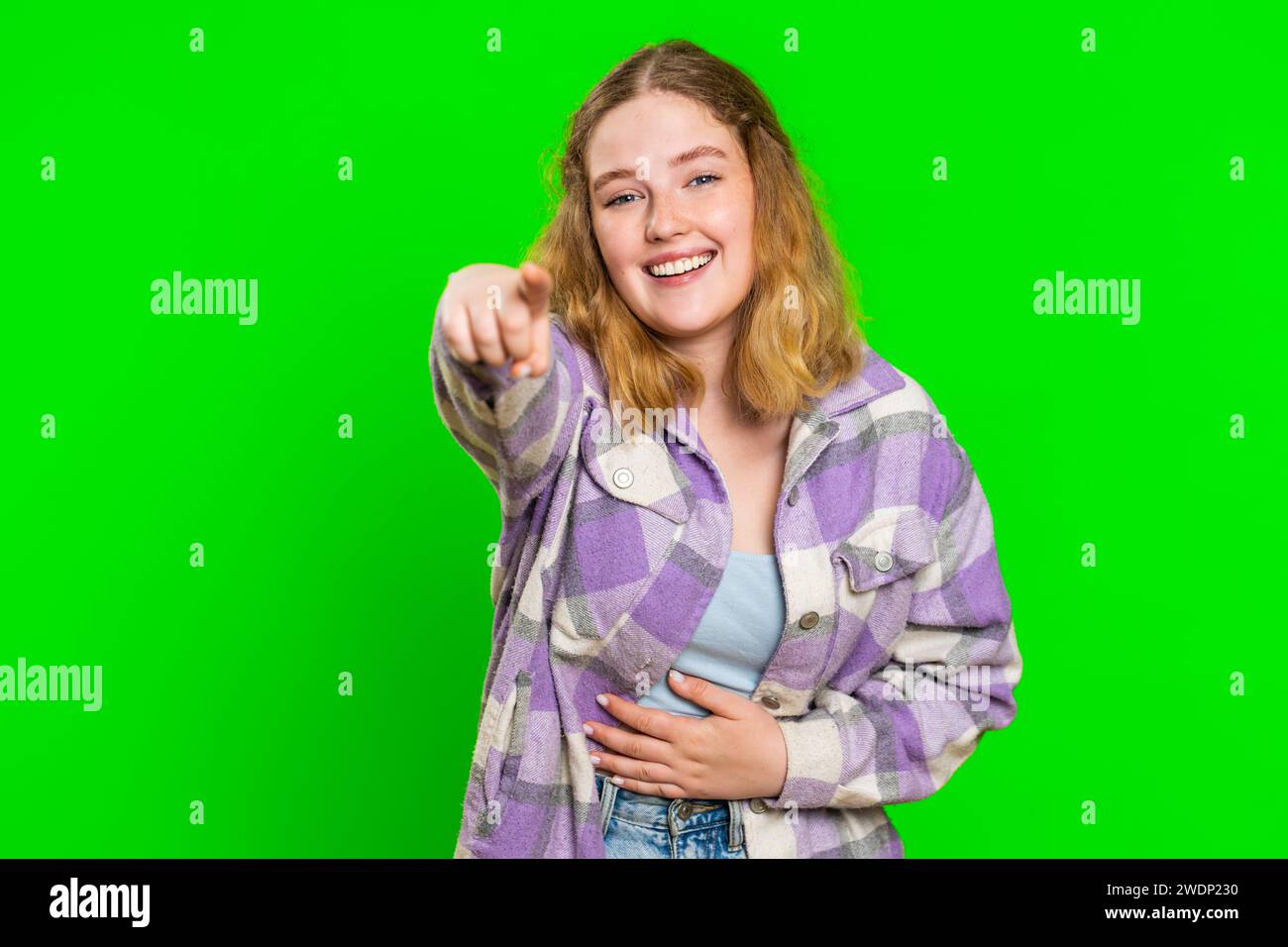 Amused lovely woman pointing finger to camera, laughing out loud ...