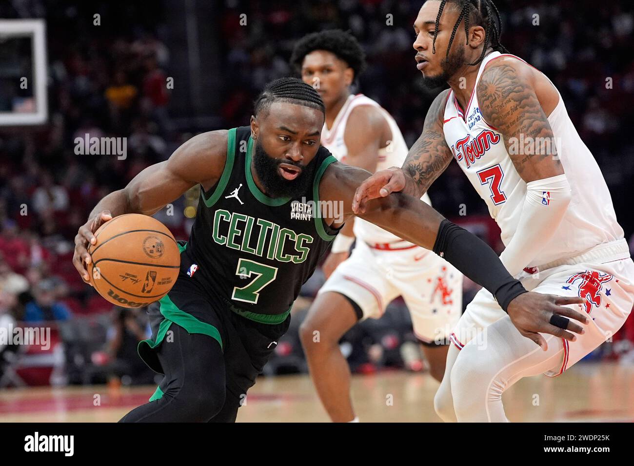 Boston Celtics' Jaylen Brown, left, drives toward the basket as Houston ...
