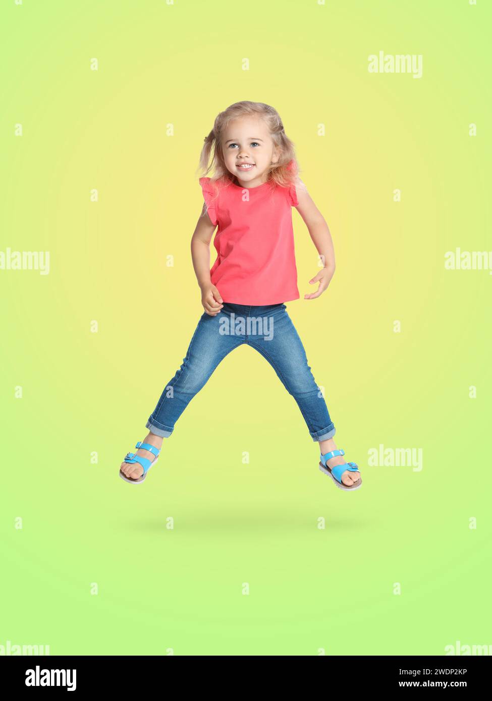 Happy cute girl jumping on color gradient background Stock Photo - Alamy