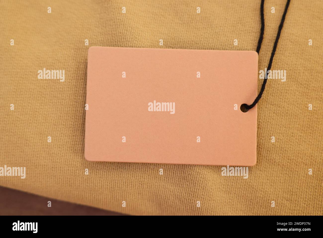 Cardboard tag on garment, closeup. Space for text Stock Photo - Alamy