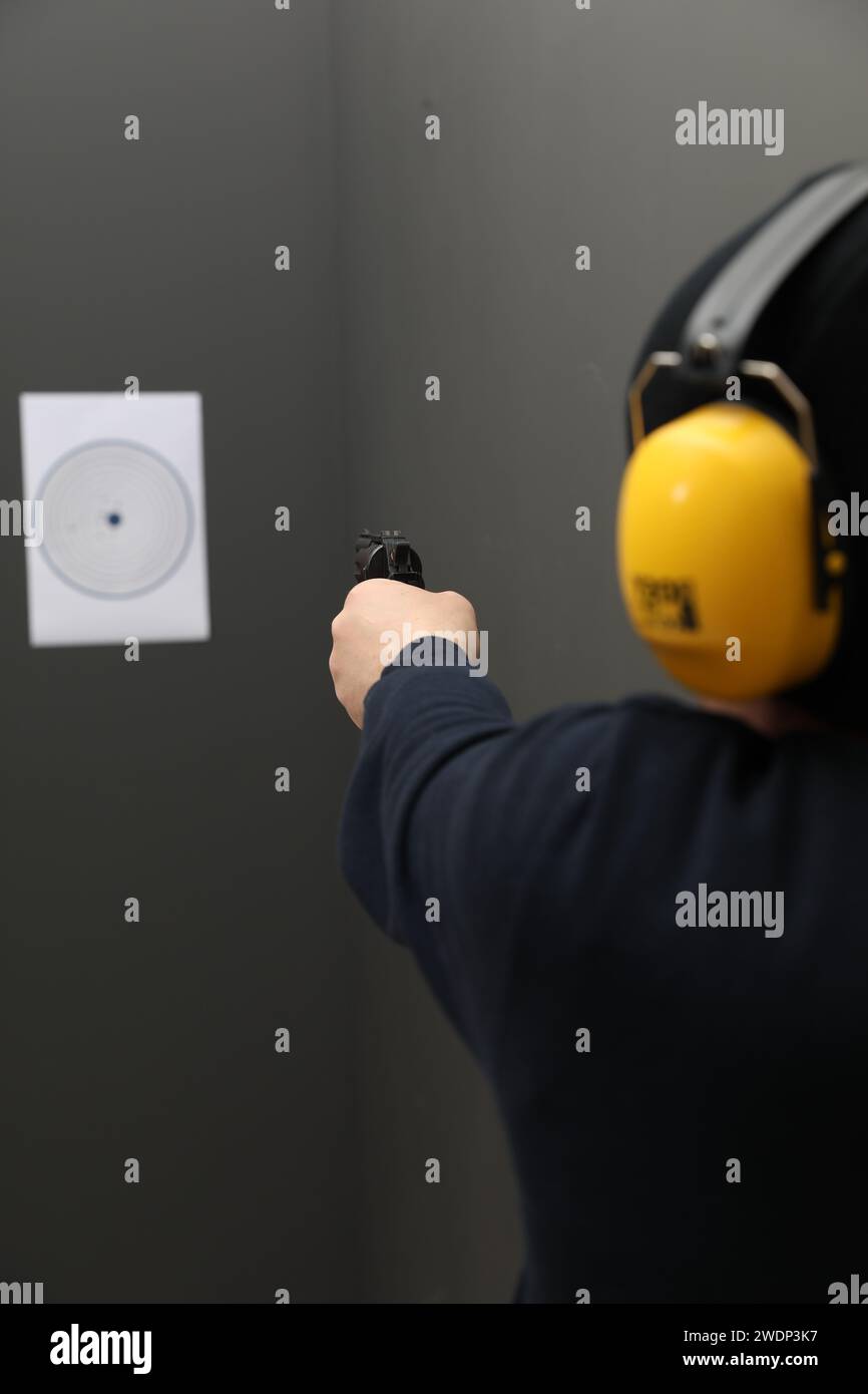 Man aiming at shooting target indoors, closeup Stock Photo - Alamy
