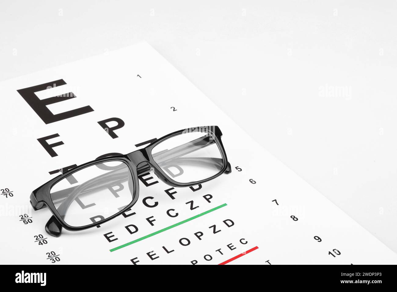 Glasses and vision test chart isolated on white Stock Photo - Alamy