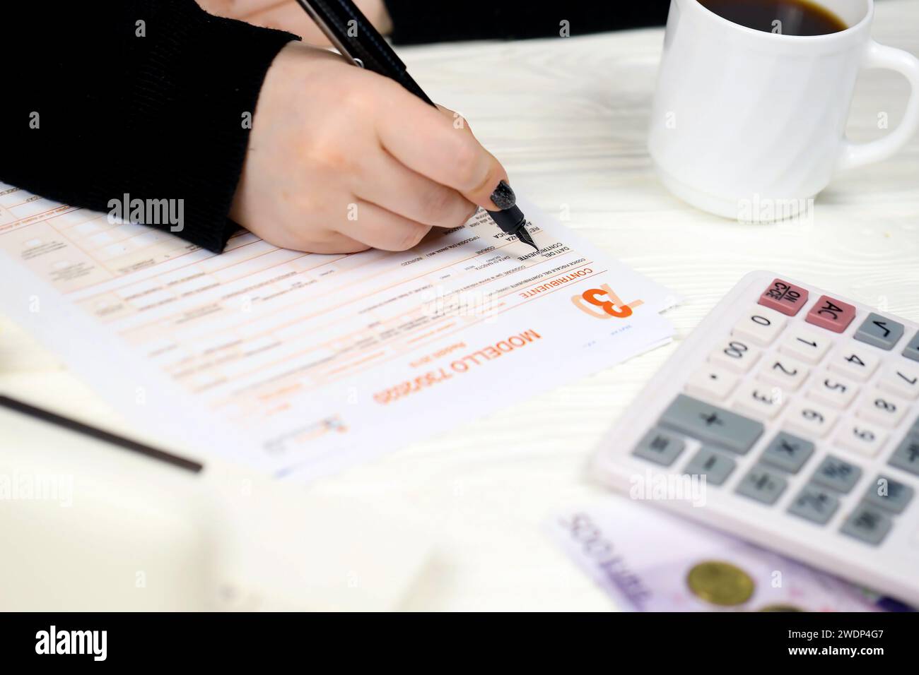 KYIV, UKRAINE - OCTOBER 31, 2023 Accountant fill italian tax form ...