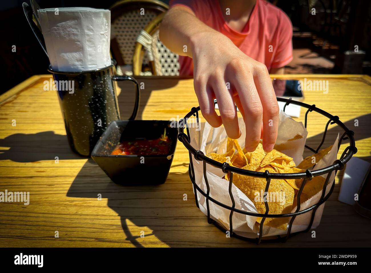 A hand reaches for tostada chips at a table in Imperial Beach ...