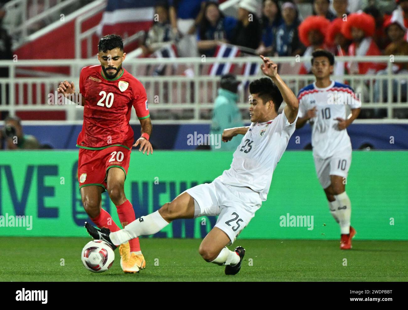 Doha, Qatar. 21st Jan, 2024. Salaah Said Al Yahyaei (L) of Oman vies against Peeradol ...