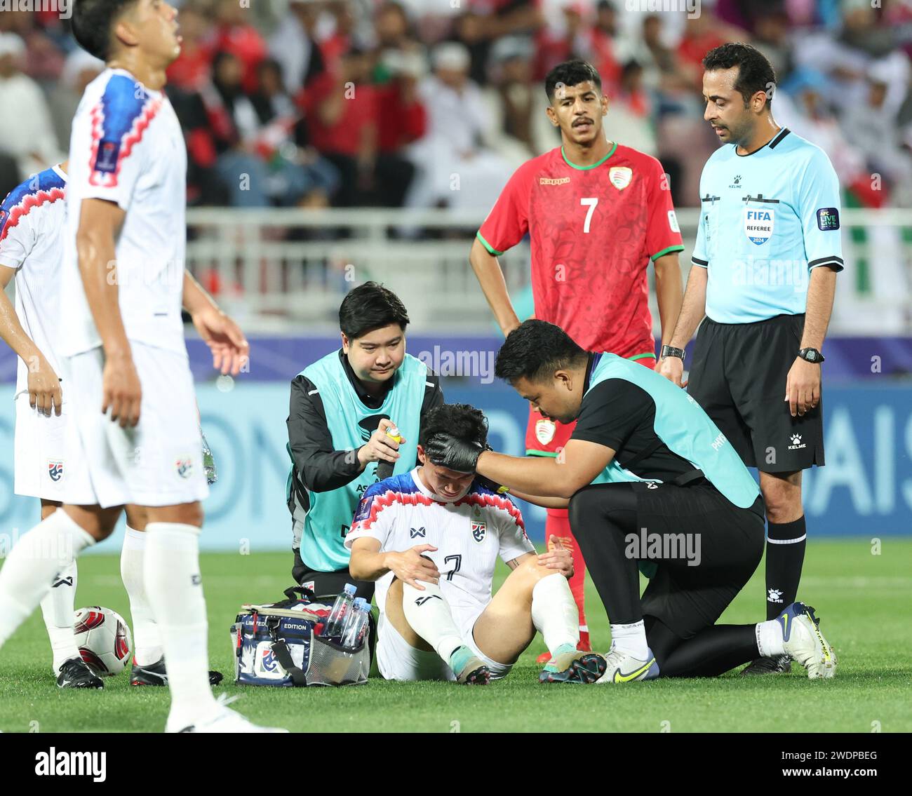 Doha, Qatar. 21st Jan, 2024. Supachok Sarachat (C) of Thailand receives ...