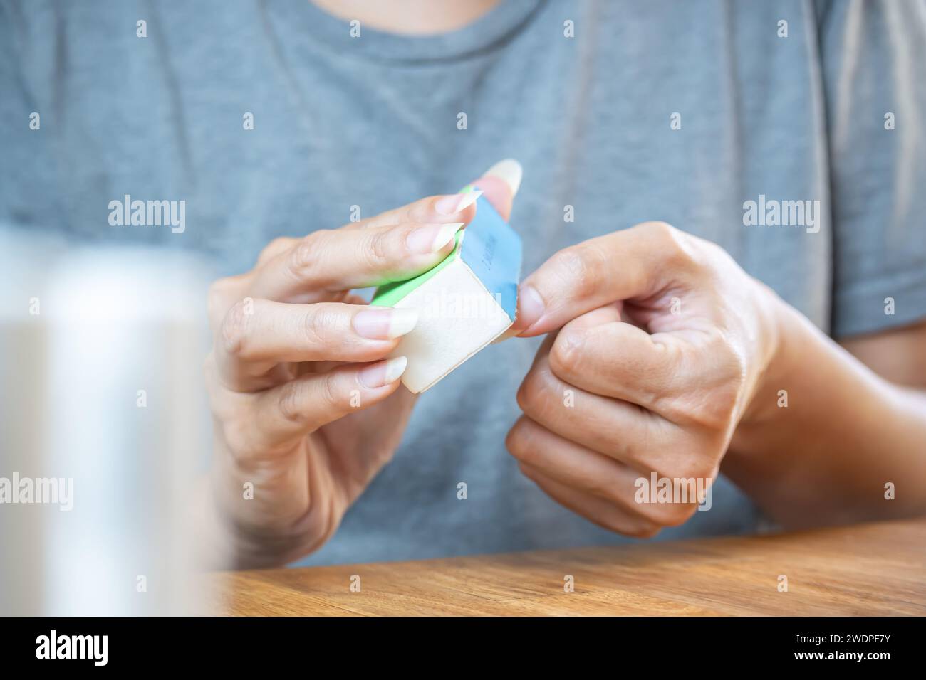 Woman's hands using a nail sponge that has different types of file ...