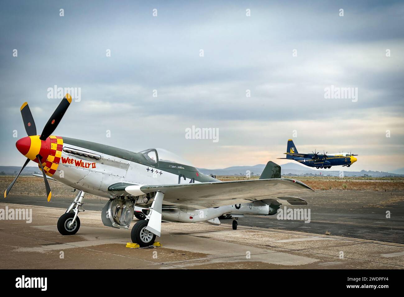 A P-51 Mustang, named Wee Willy II, sits on the tarmac while the US ...