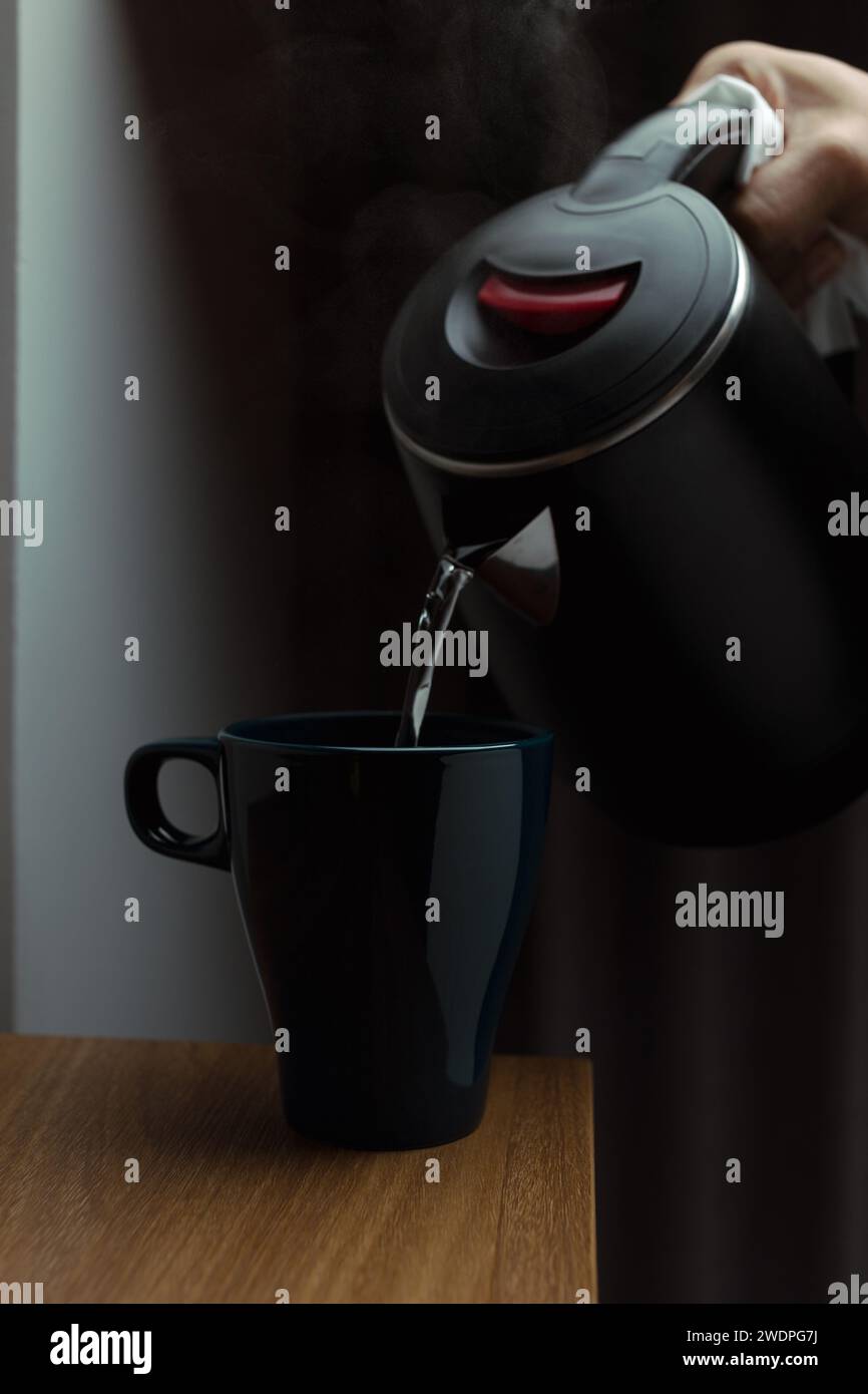Pouring hot water at night Stock Photo - Alamy