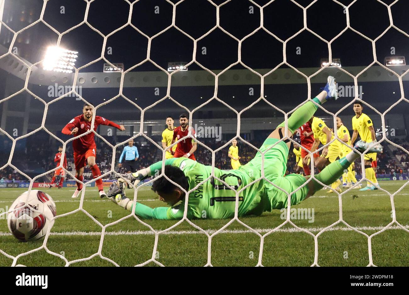 Beijing, Qatar. 20th Jan, 2024. Ahmad Syihan Hazmi (front), goalkeeper ...