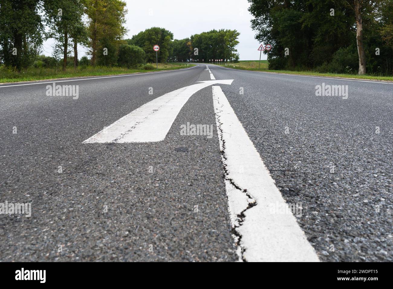 Asphalt road with markings indicating the end of the overtaking ...