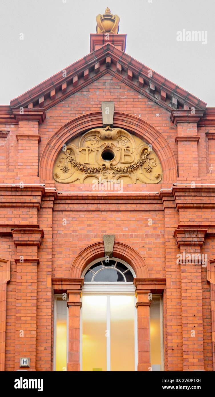 A vertical of a red brick building with ornate roof Stock Photo - Alamy