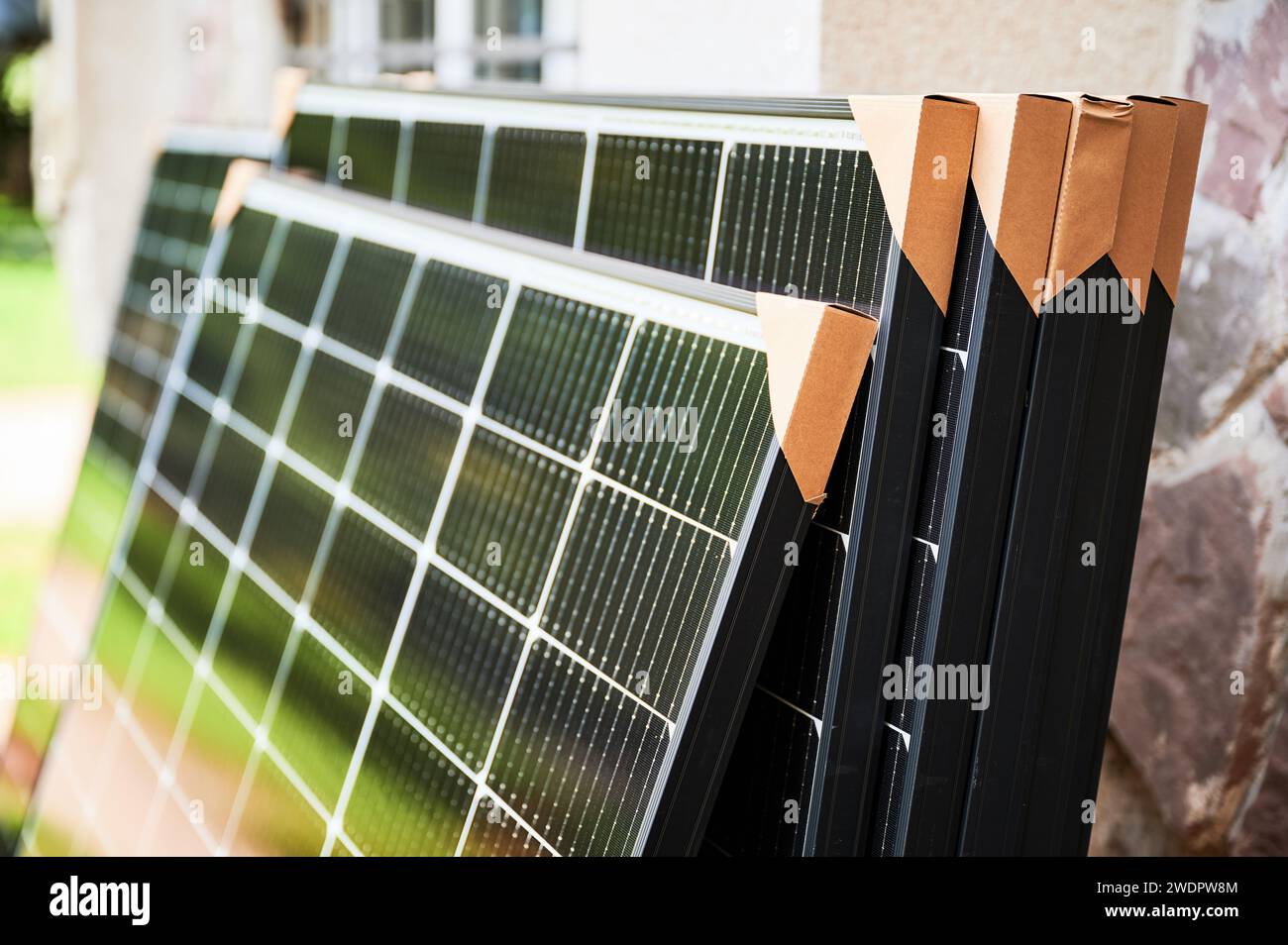 Close-up new solar panels with protective cardboard corners, ready for ...