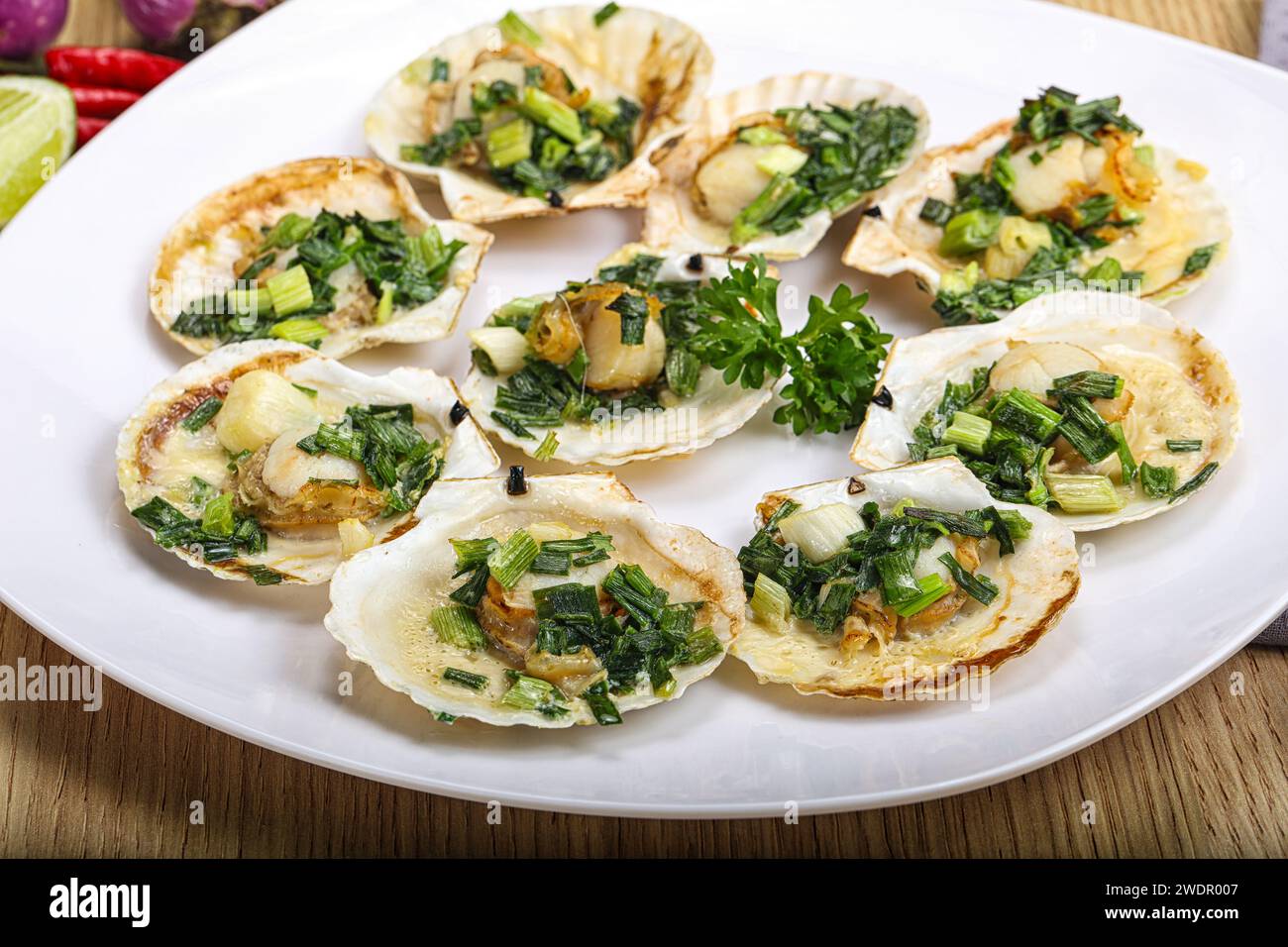 Grilled scallops with green onion and sauce Stock Photo - Alamy