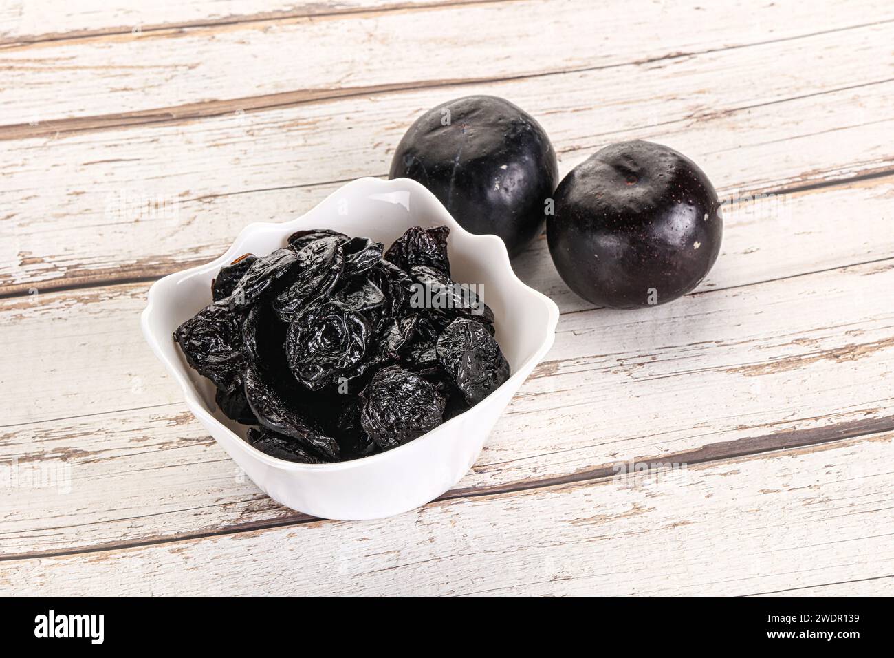 Dry sweet prunes in thw bowl Stock Photo - Alamy