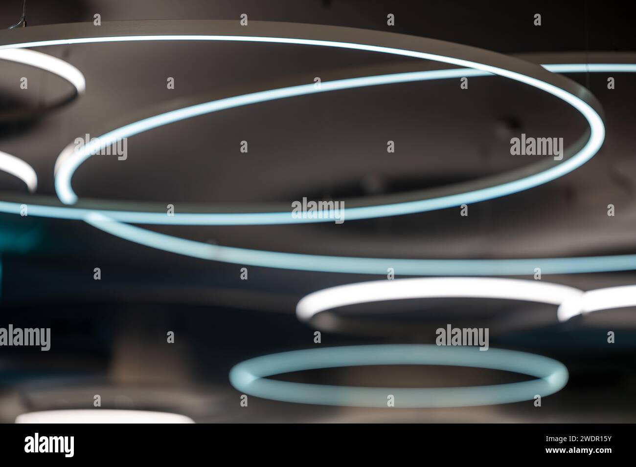 The circular pendant lights hanging from the ceiling Stock Photo - Alamy