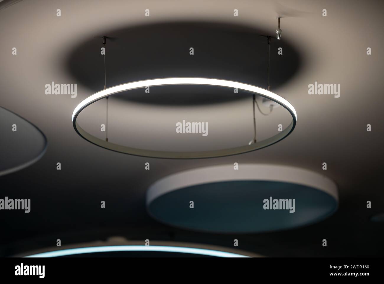 The circular pendant lights hanging from the ceiling Stock Photo - Alamy