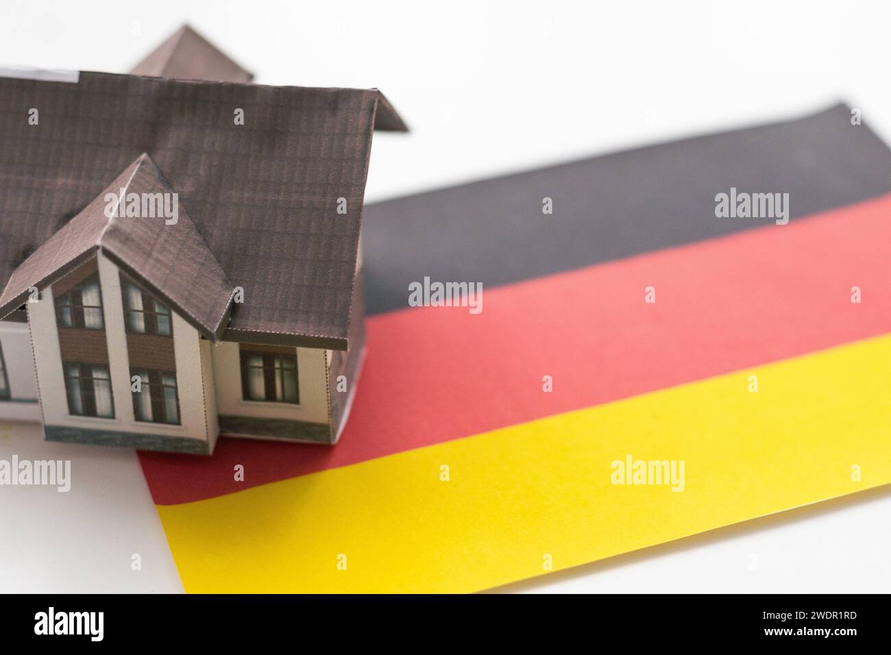 Small house on a flag - Living or migrating to Germany Stock Photo - Alamy